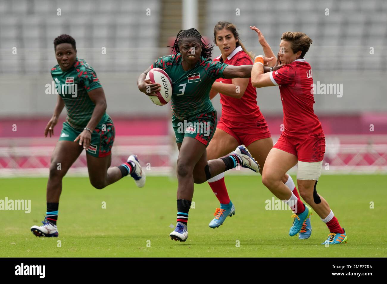 Kenya's Sheila Chajira, center, holds off Canada's Ghislaine Landry, in ...