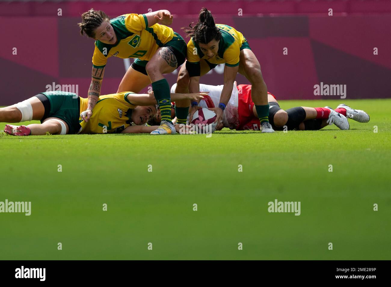 Brazil's Aline Furtado, bottom left, passes the ball through the legs ...