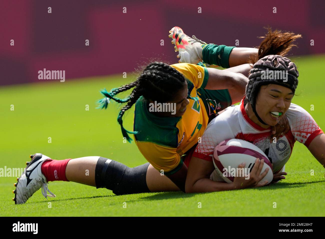 Japan's Haruka Hirotsu, right, is tackled by Brazil's Thalia da Silva ...