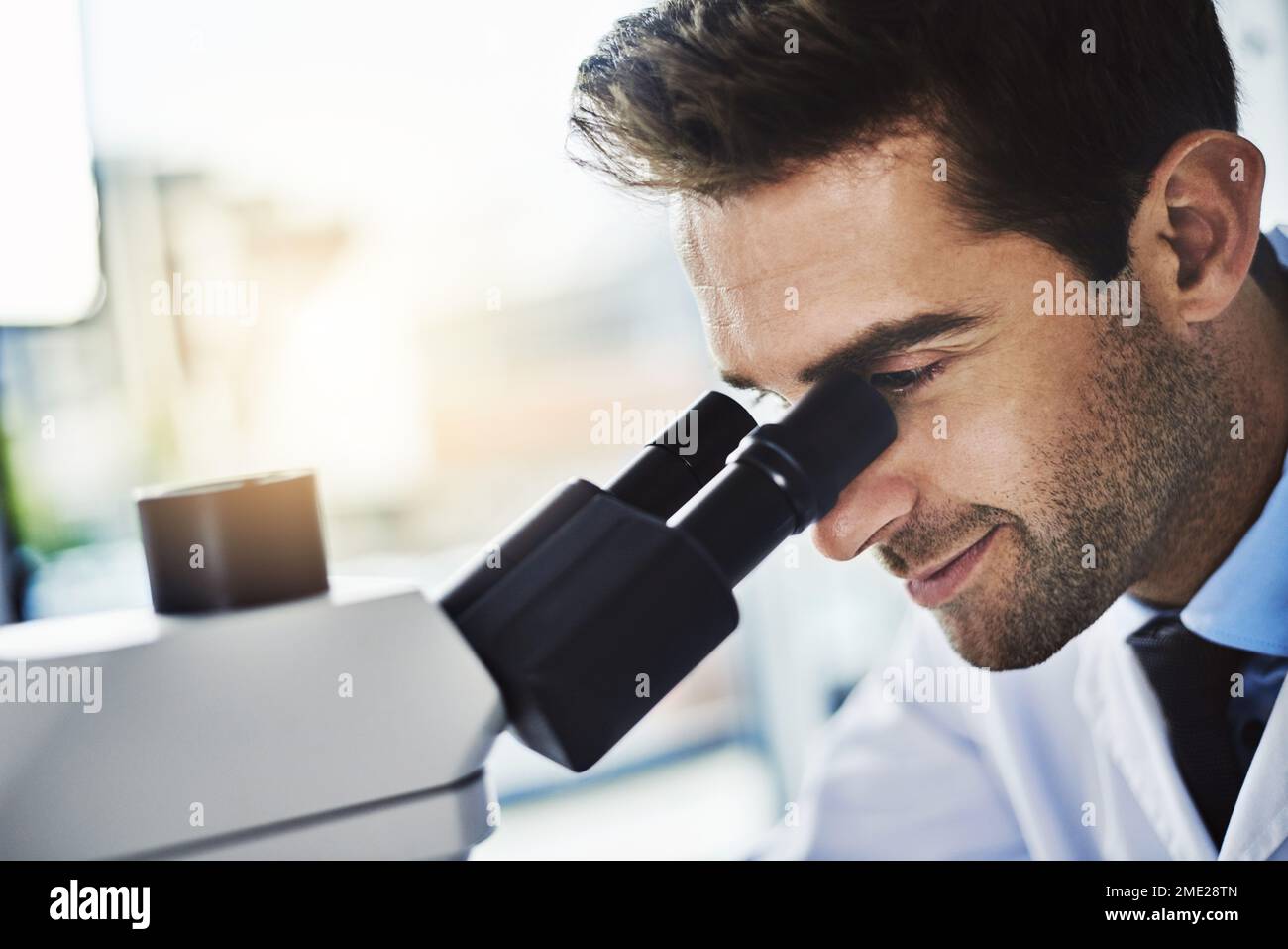 Paying close observation to his findings. a scientist using a ...