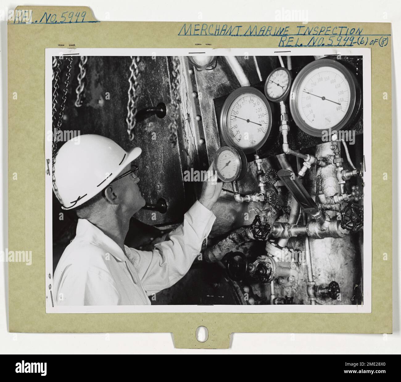 A Coast Guard inspector checks the boiler gauge aboard the City of ...