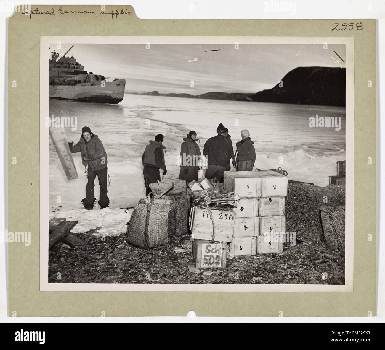 Coast Guardsmen deliver captured supplies from a Nazi weather station ...