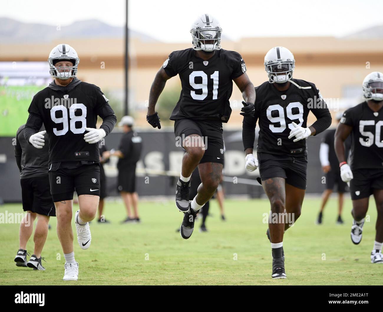 Las Vegas Raiders defensive ends Maxx Crosby (98), Yannick Ngakoue (91) and Clelin Ferrell (99 ...