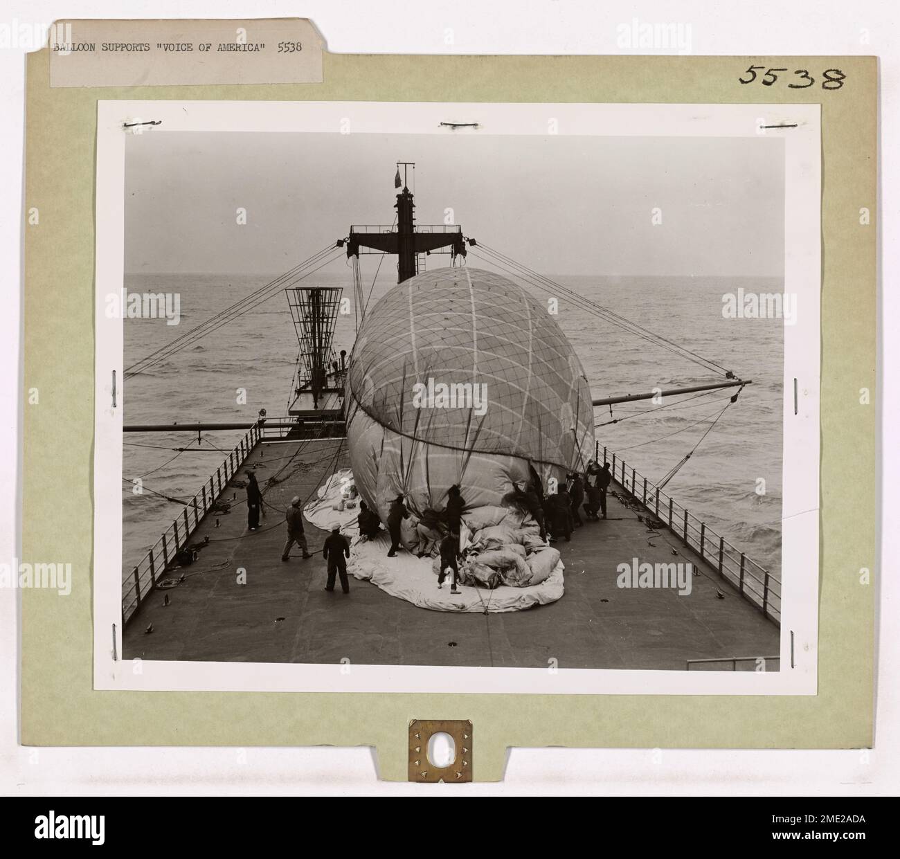 Members of the U.S. Coast Guard are shown removing the restraining net ...