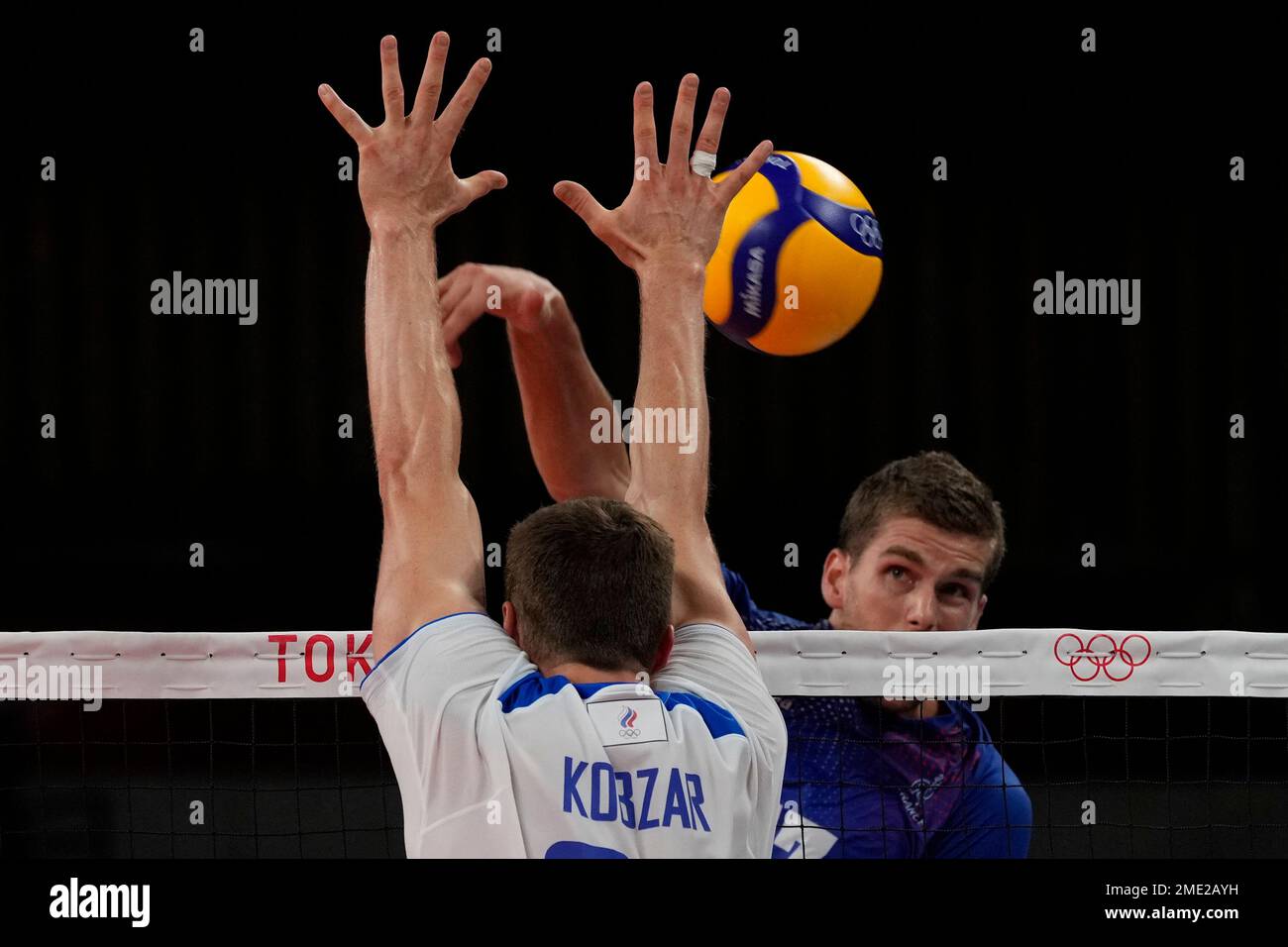 France's Trevor Clevenot spikes a ball against Igor Kobzar, of the ...