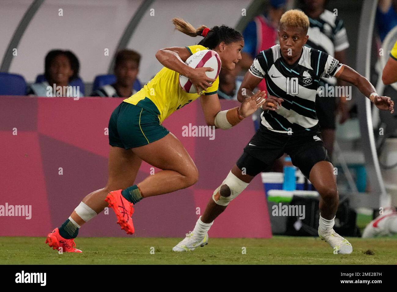 Australia's Faith Nathan is eyed by Fiji's Alowesi Nakoci as she runs ...