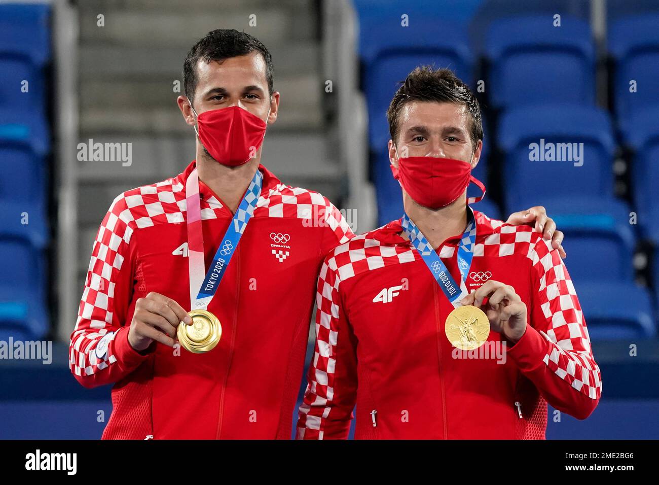 Mate Pavic, left, and Nikola Mektic, of Croatia, pose with their gold ...