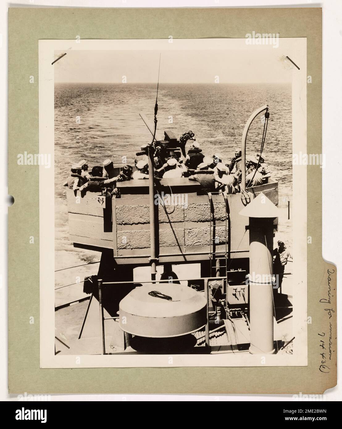 This image shows Coast Guardsmen manning the gun of a Coast Guard ...