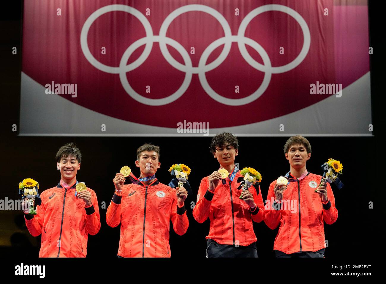Japan team celebrate on the podium after winning a men's Epee team ...
