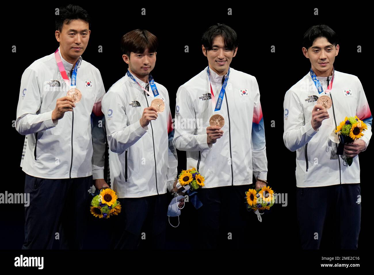 Bronze medalists from South Korea celebrate on the podium during the ...