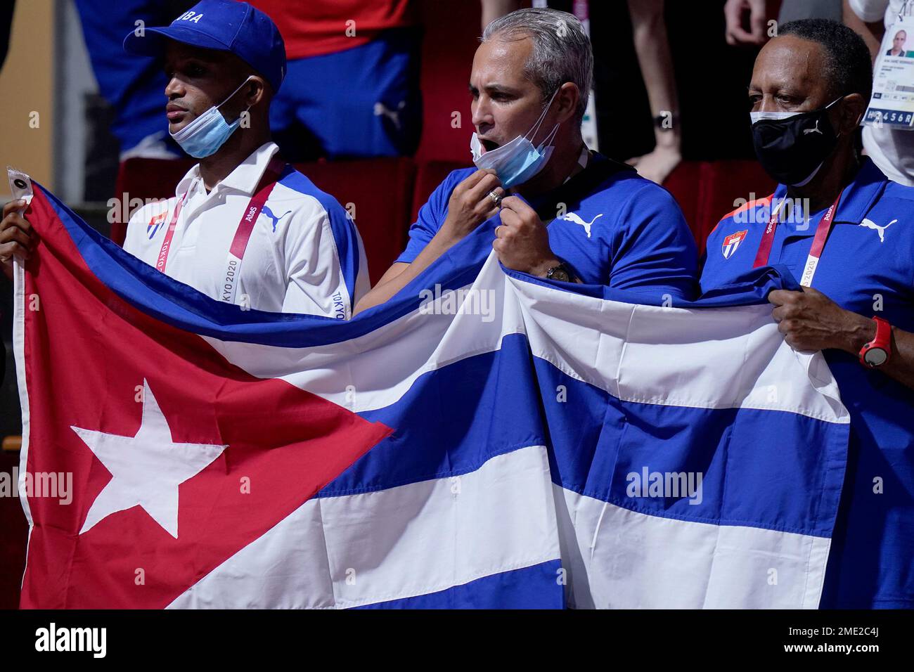 People with a flag of Cuba's watch the men's heavyweight 91-kg boxing ...