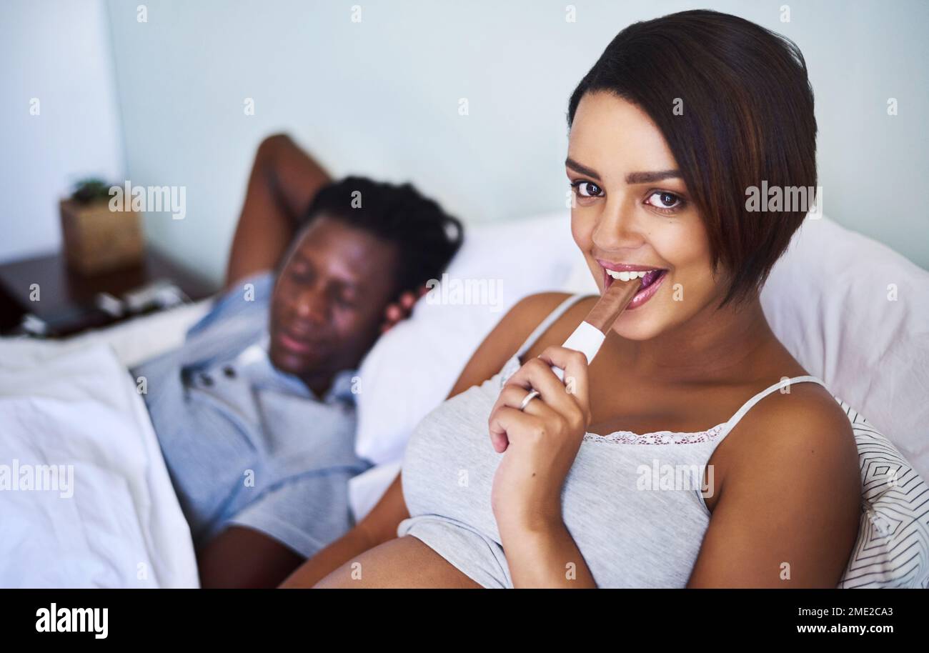 Mommy needs something sweet. a pregnant woman enjoying a chocolate ...