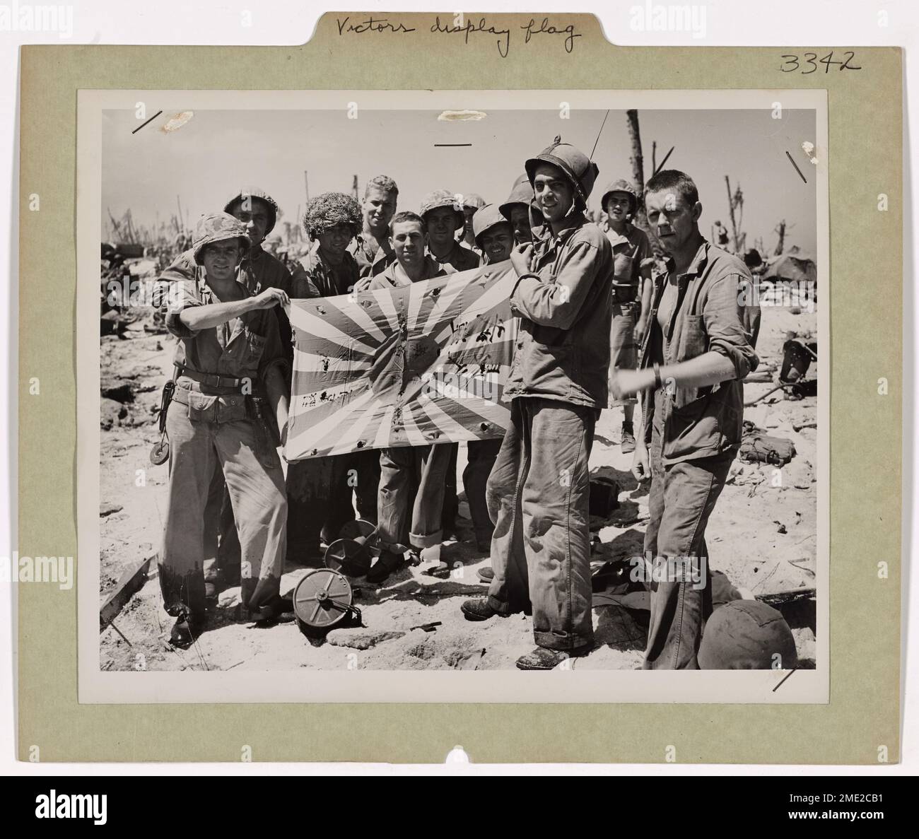Marines and Coast Guardsmen display a bullet-riddled Japanese flag ...