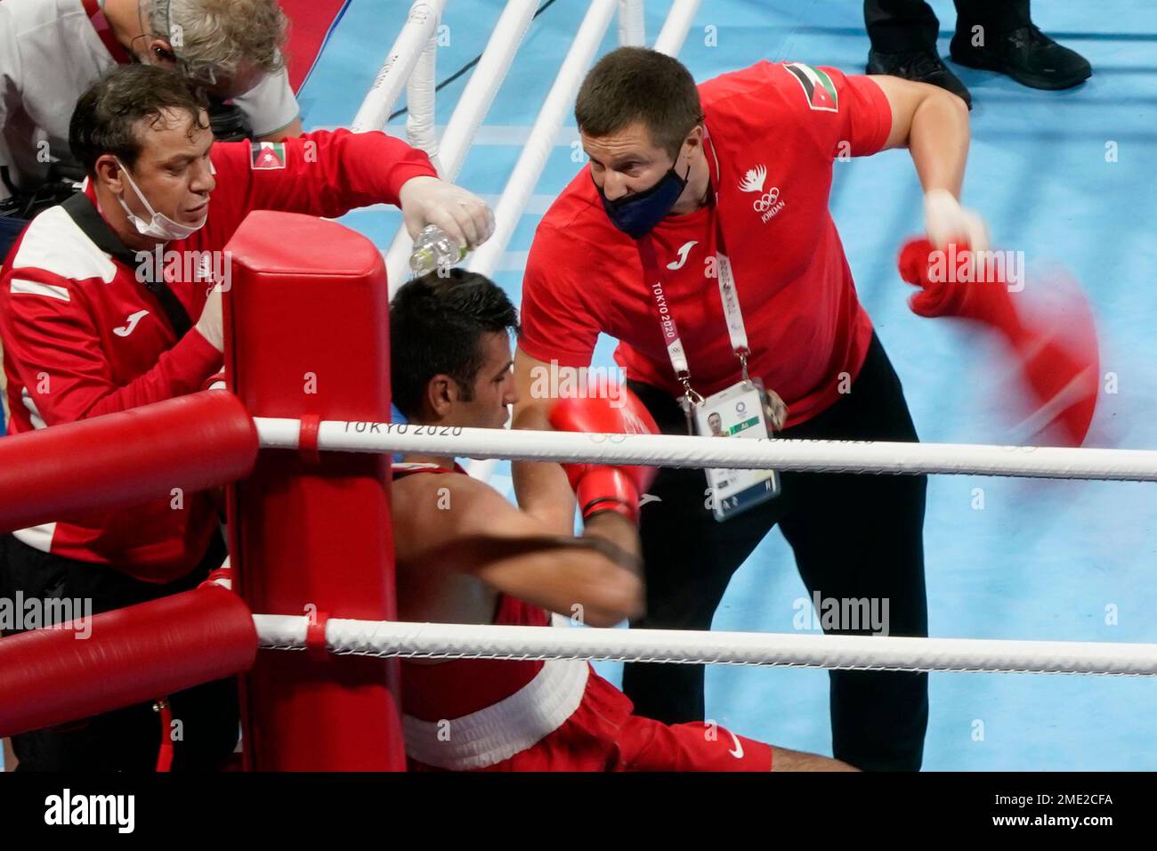 Jordan's Hussein Eishaish Hussein Iashaish, is cooled in his corner between rounds of his men's ...