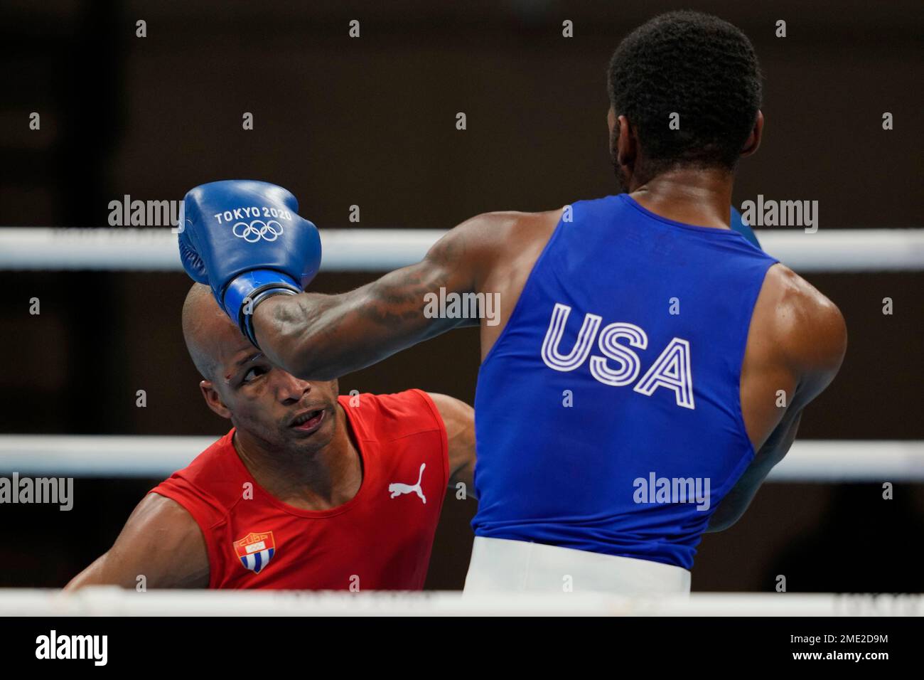 Cuba's Roniel Iglesias, left, exchanges punches with Delante Johnson ...