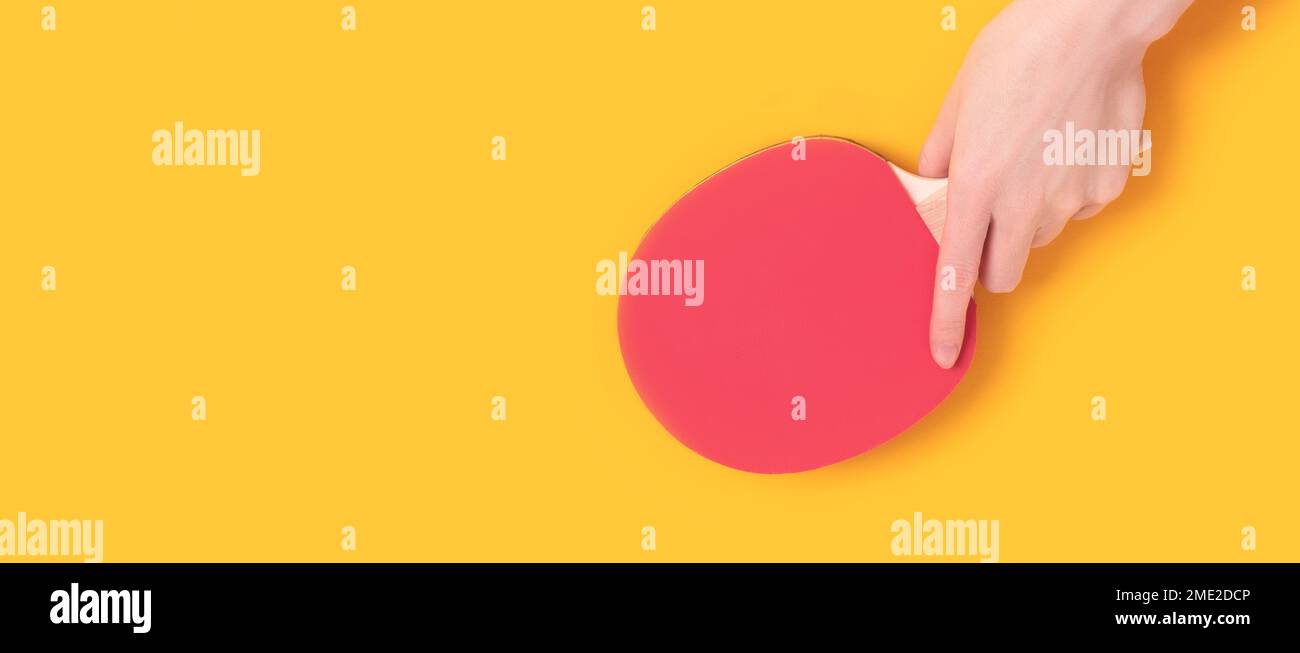 Banner with female hand hold racket for ping pong on a yellow ...