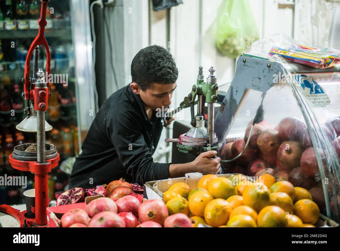 Street scene with boy making pomegranade juice in the Betlehem, Israel ...