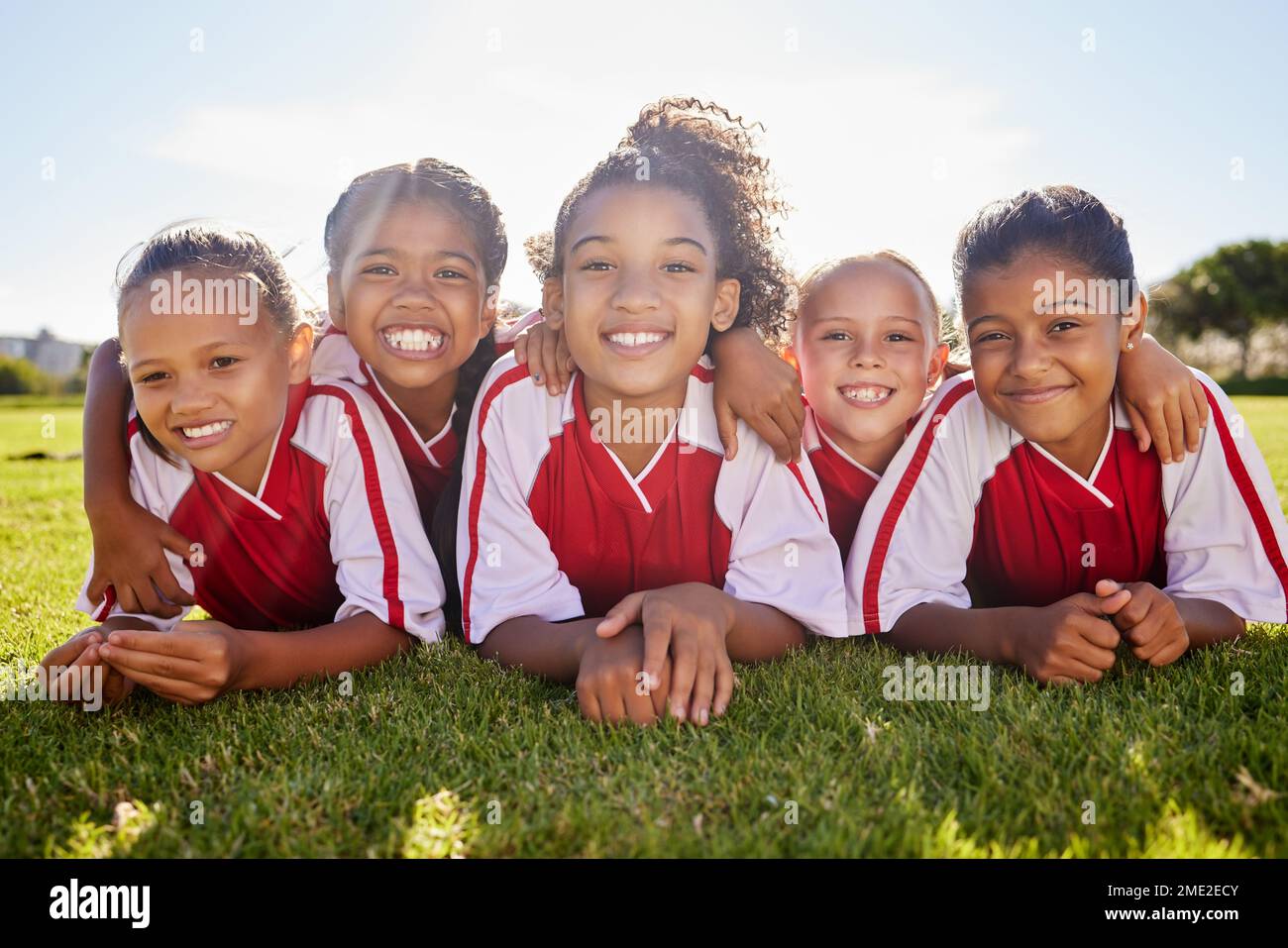 Girl, soccer group portrait and lying with smile, team building ...