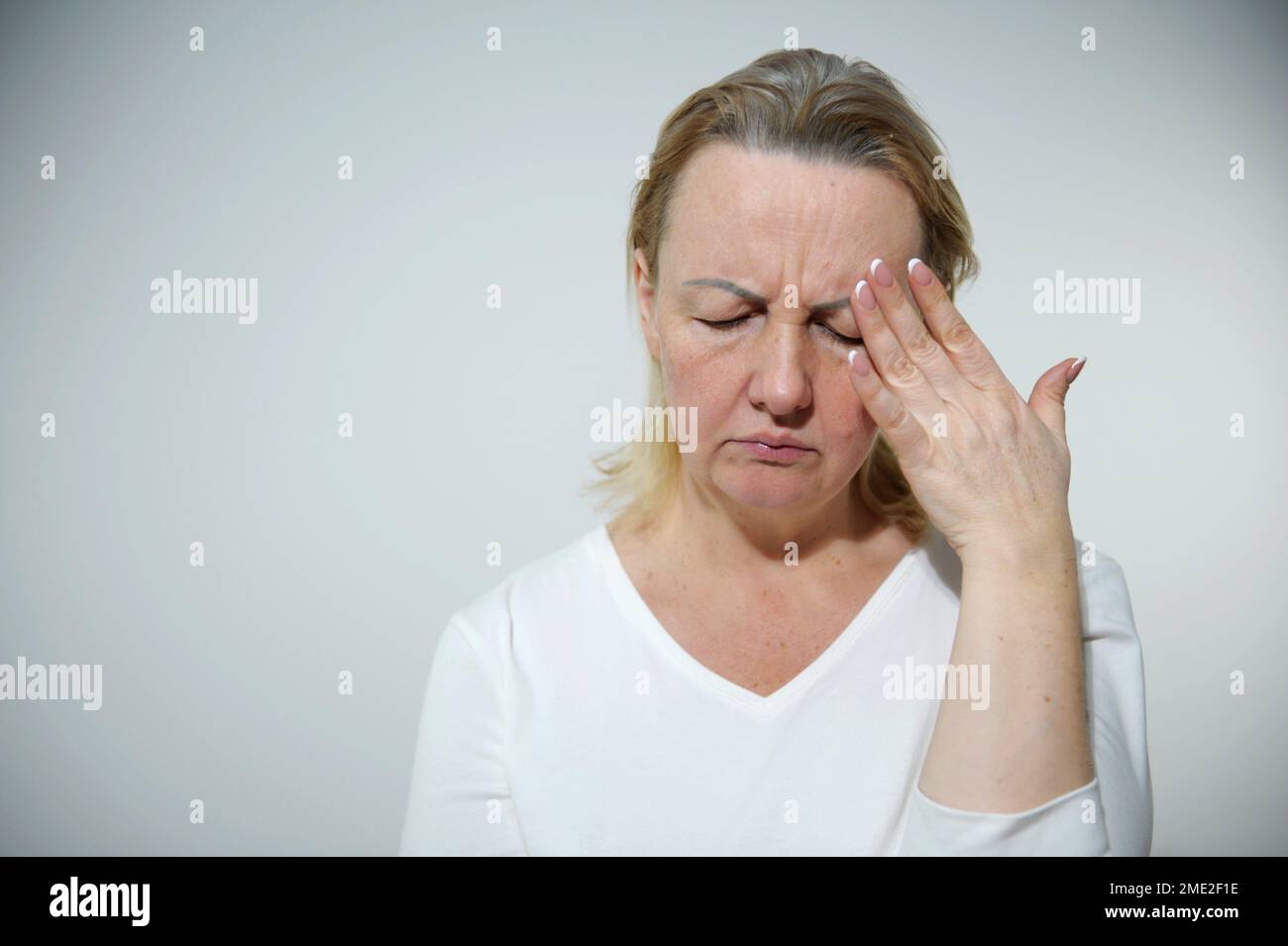 woman put her hand on her head and grimaced headache hard time woman ...