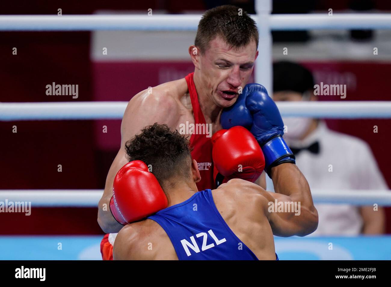 David Nyika, of New Zealand, in blue, and Belarus' Uladzislau ...