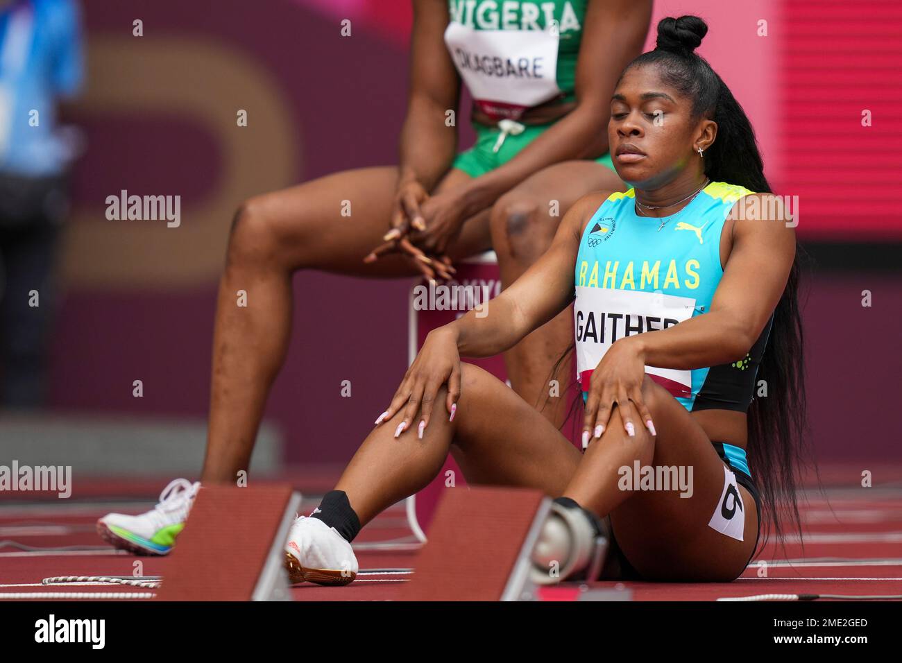 Tynia Gaither, of Bahamas, waits to start in her heat of the women's ...