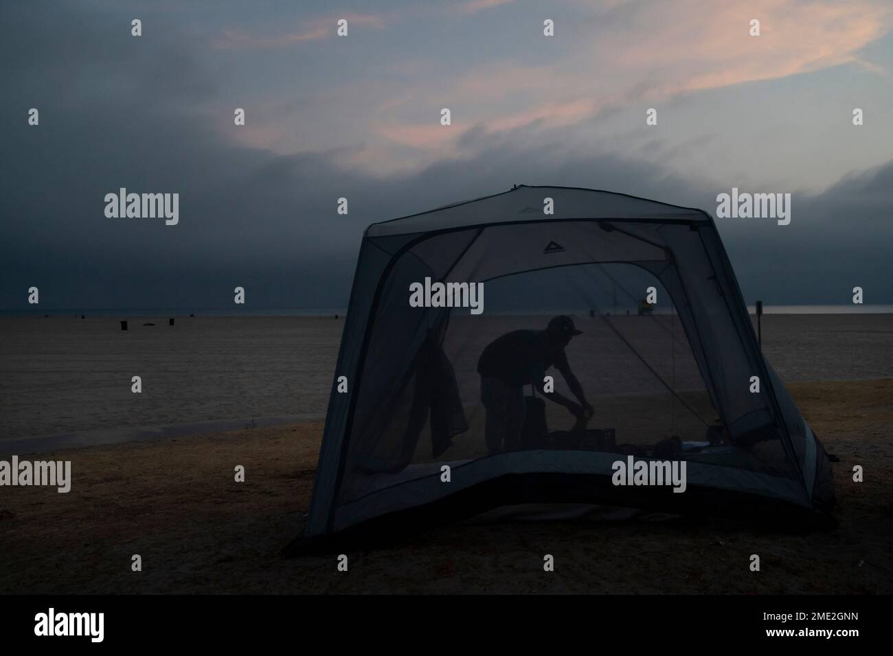 Marc Dilk, a 32-year-old homeless man, tidies up around his tent on the ...