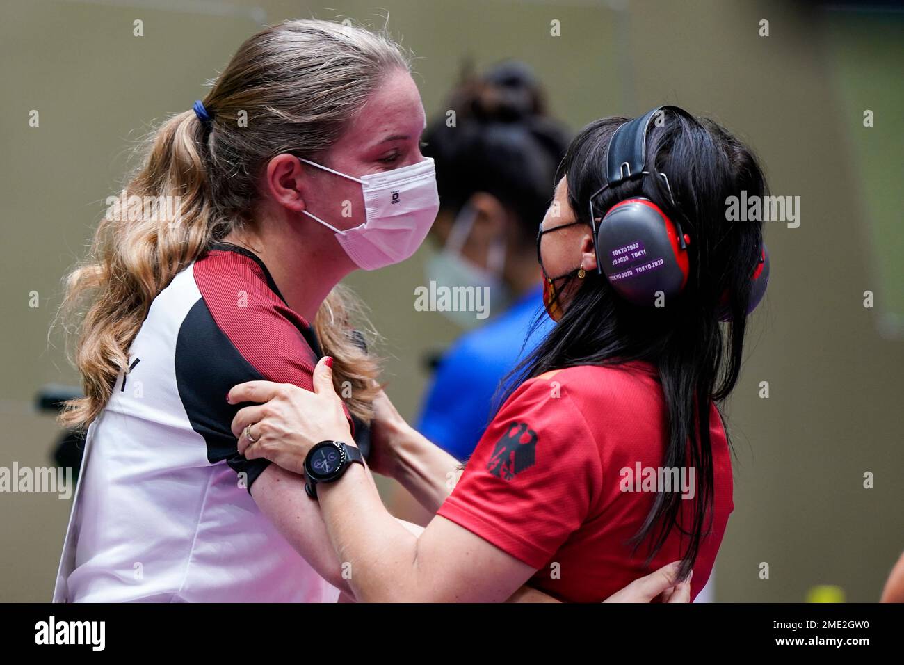 Doreen Vennekamp, left, of Germany, hugs her coach after competing in ...