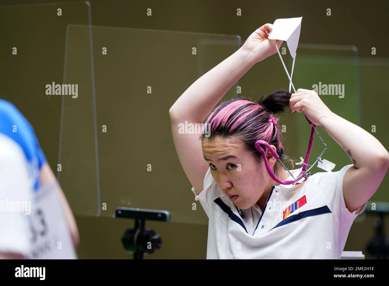 Anudari Tsolmonbaatar, of Mongolia, removes her protective mask before ...