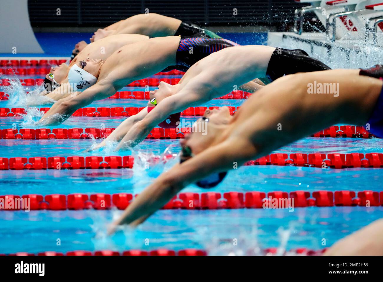 Evgeny Rylov, of Russian Olympic Committee, white cap, dives off the ...