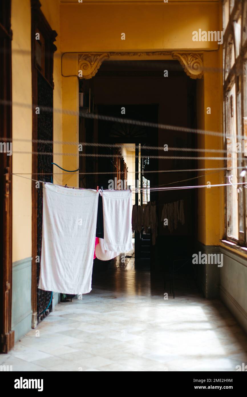 Interior of corridor with drying ropes and hanging while clothes during ...