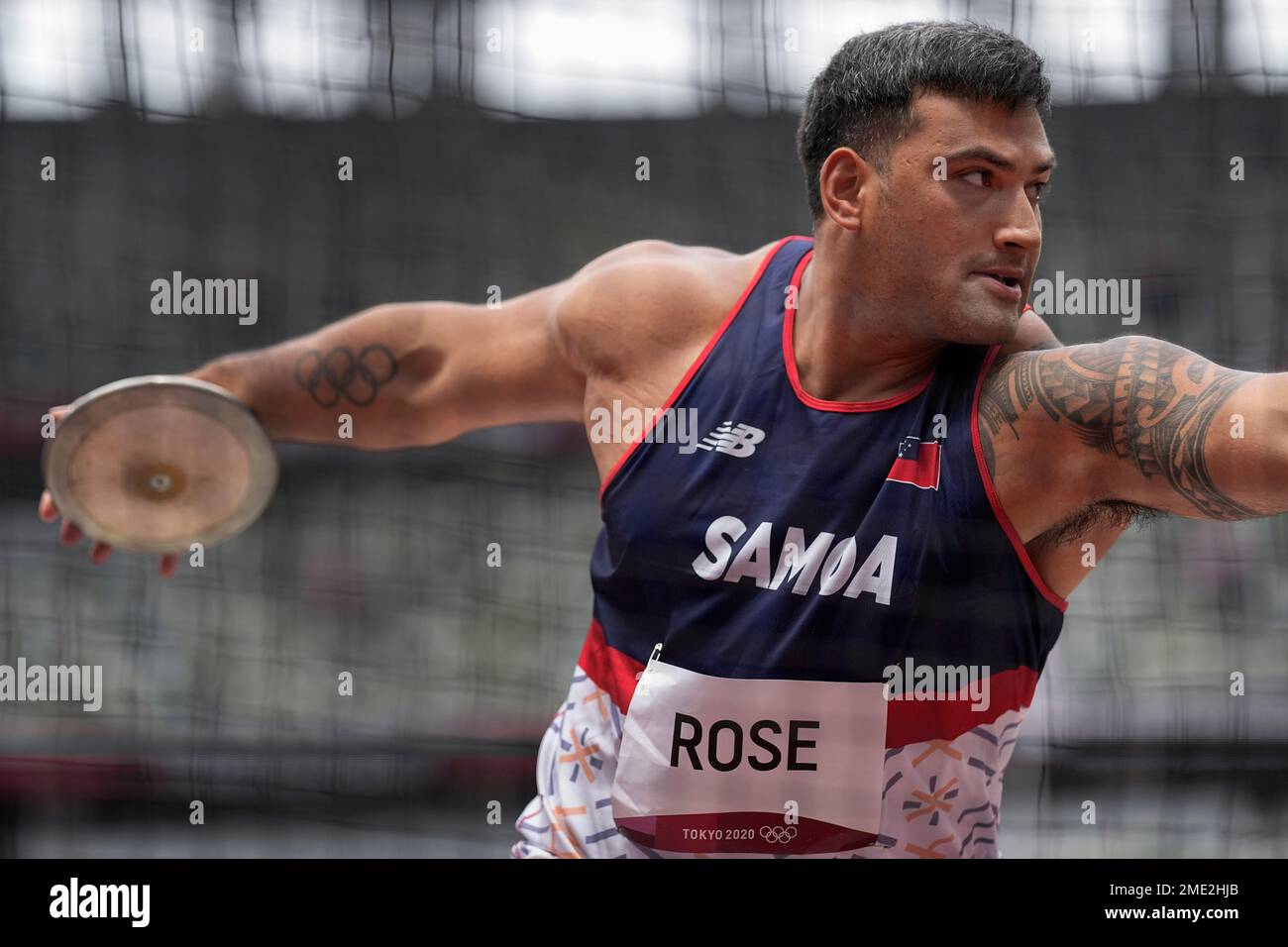 Alex Rose, of Samoa, competes in his heat of the men's discus throw at ...