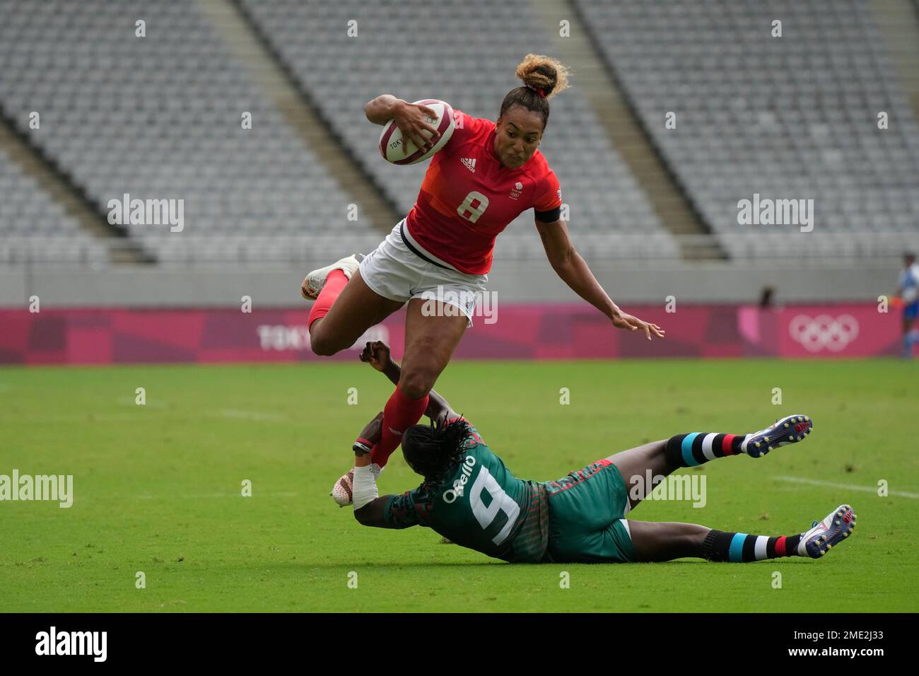 Britain's Celia Quansah leaps to avoid a tackle by Kenya's Janet Okello ...