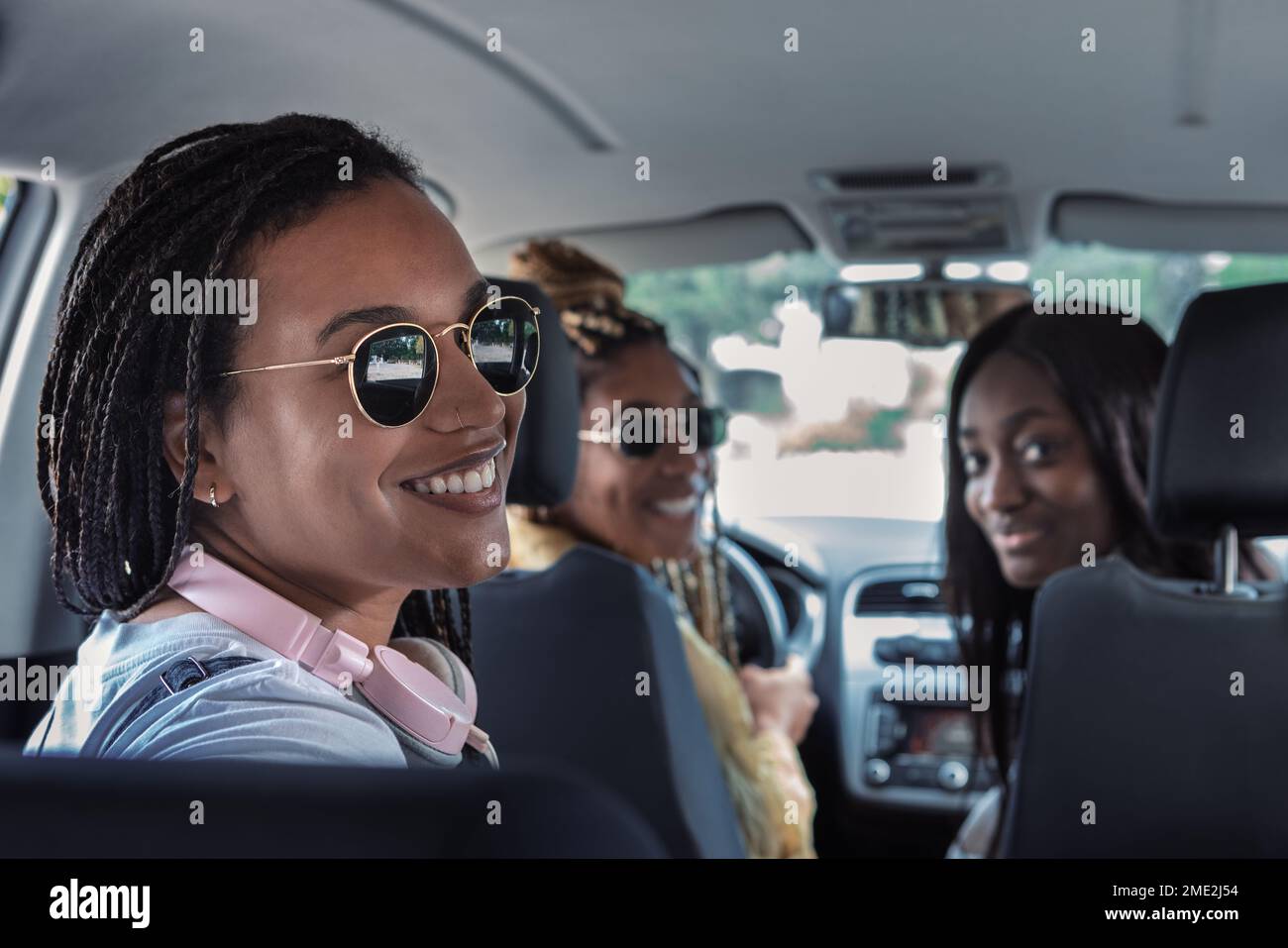Group of smiling African American female friends looking at camera over ...