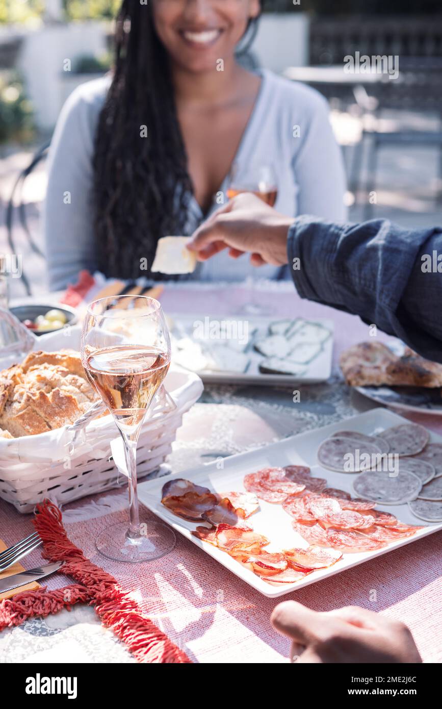 From above group of crop people eating snacks and drinking sparkling ...