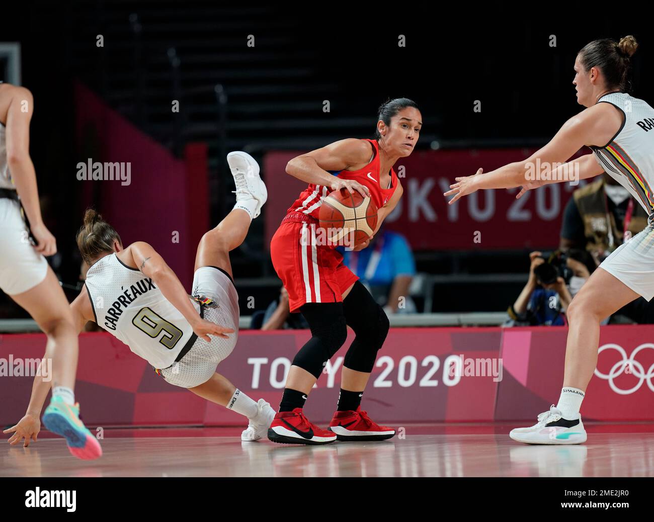 Puerto Rico's Michelle Gonzalez (91) drives between Belgium's Marjorie ...