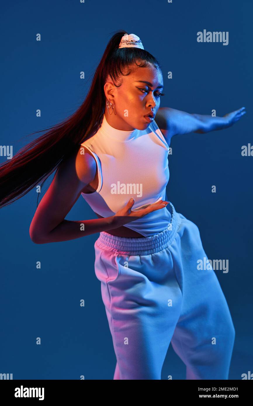 Young talented female dancer with long straight ponytail in white ...