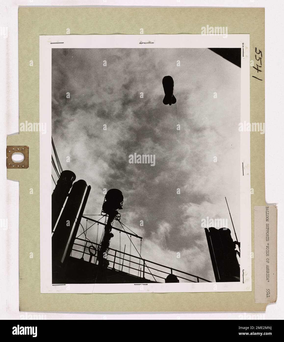 A captive balloon, raised approximately 900 feet above a ship, supports ...