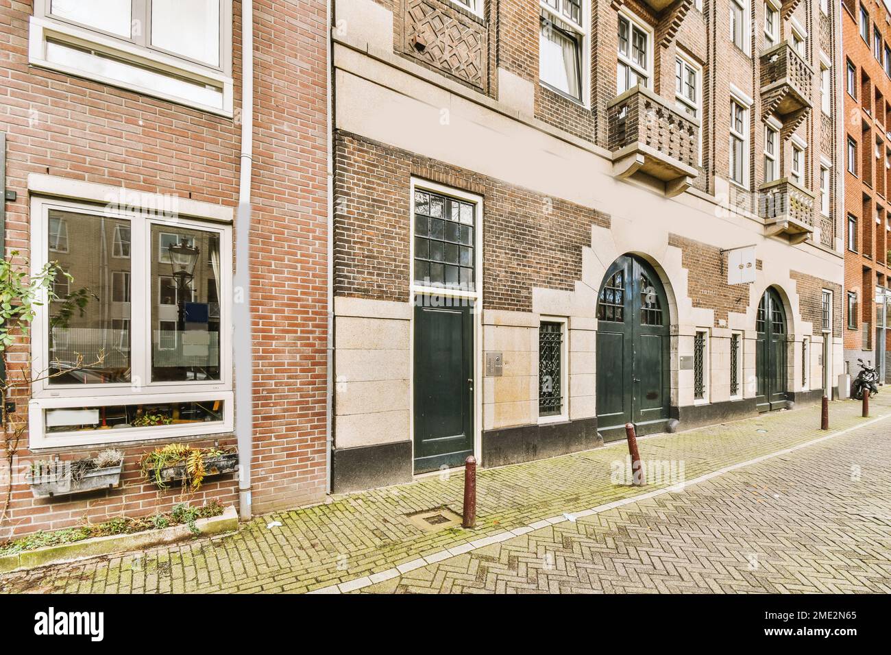 Facade of brick buildings with windows and balconies located on street ...