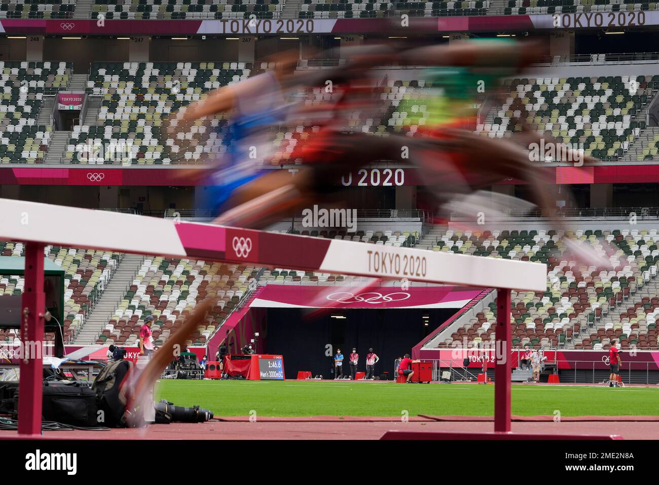 Runners compete in a heat of the men's 3,000-meter steeplechase at the ...