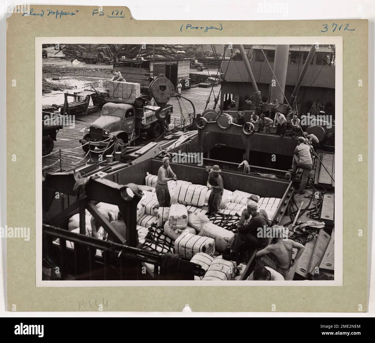 This image depicts an army Freight Supply (FS) ship offloading supplies ...