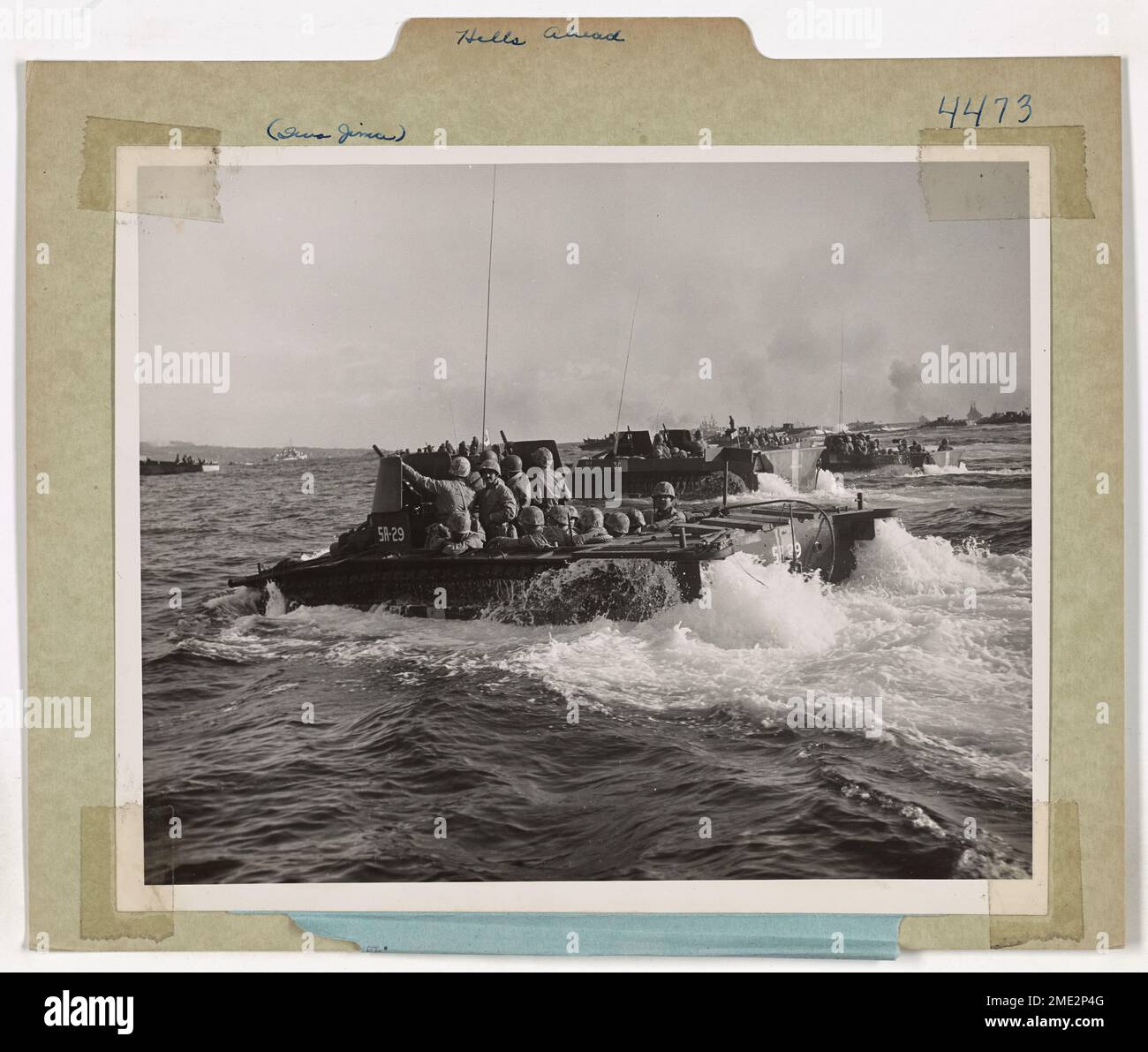This image shows amphibious tractors (amtracs) charging the beaches of ...