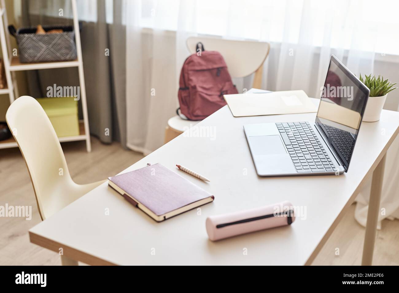 Background image of students desk at home with open laptop and backpack ...