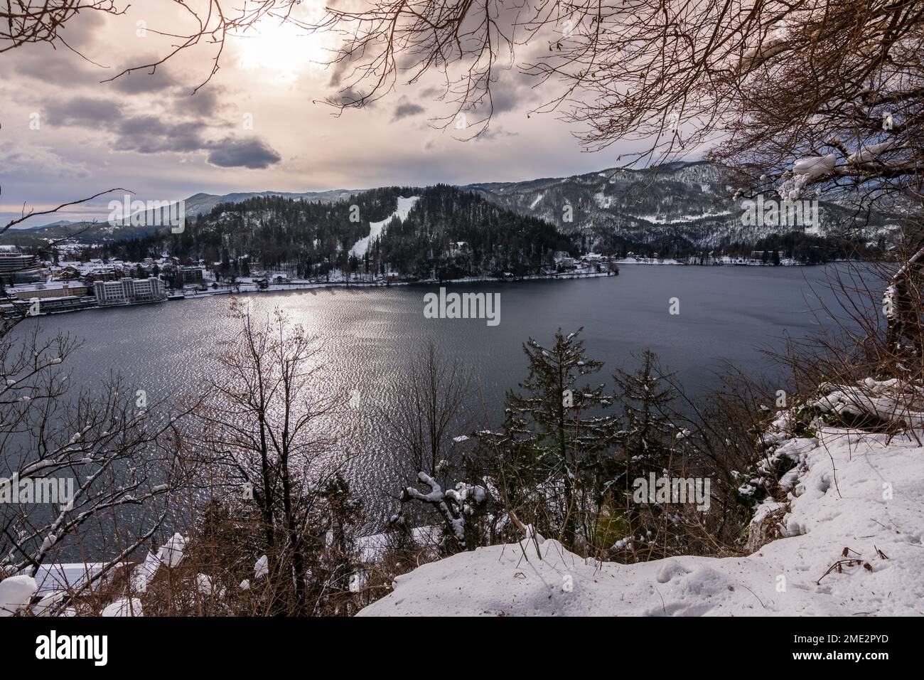 Glimpse of Lake Bled from the climb towards the castle. Winter day with ...