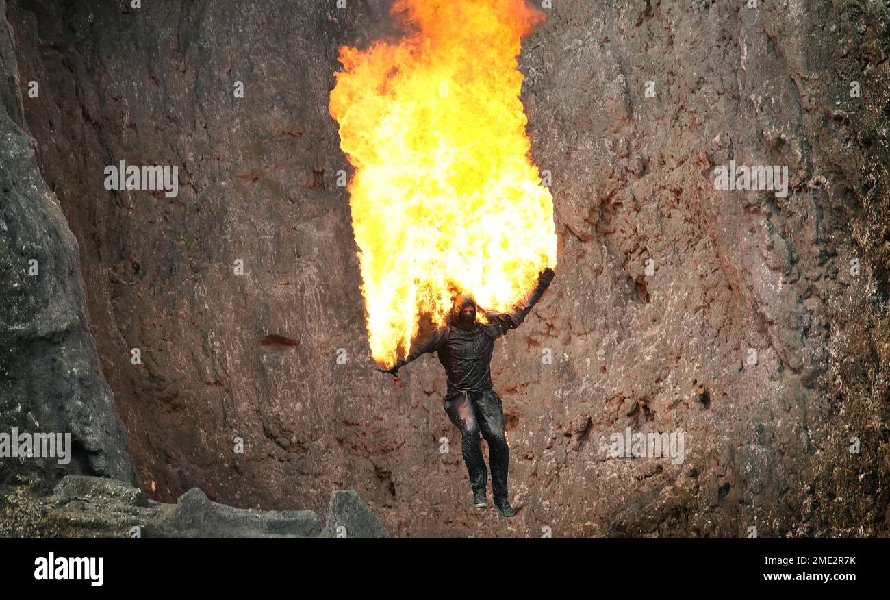 A burning stuntman jumps into the deep during an explosion as part of a ...