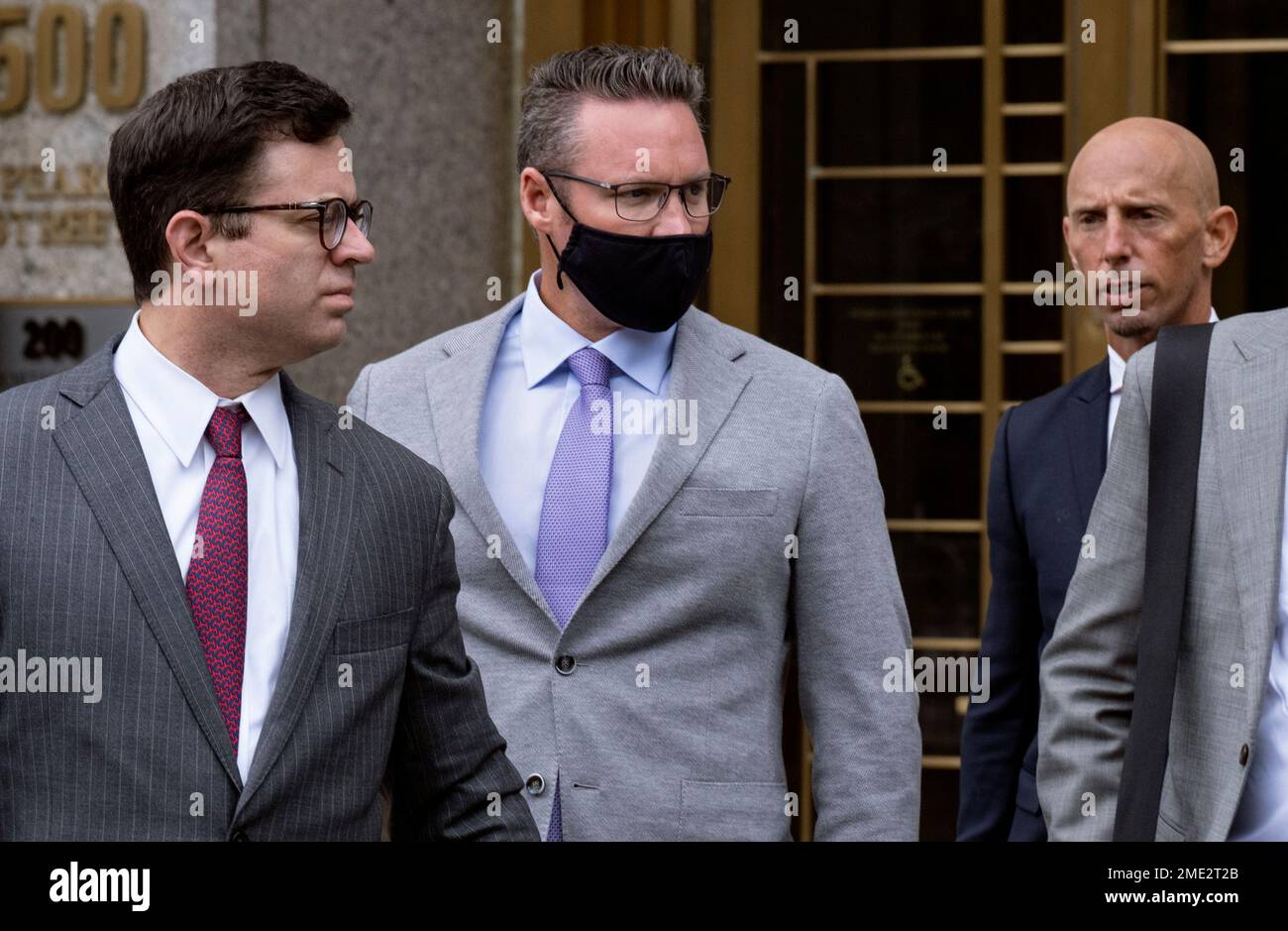 Nikola founder Trevor Milton, center, leaves a federal courthouse in ...