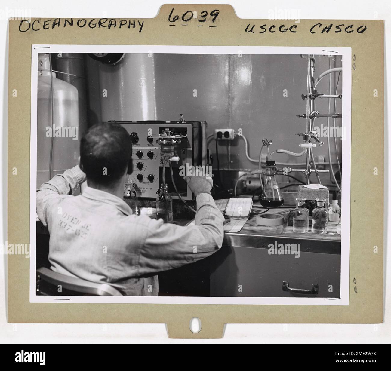 A crew member aboard the U.S. Coast Guard Cutter Casco tests sea water ...