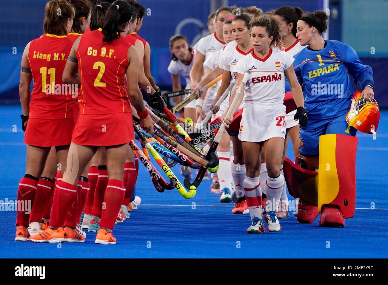 Spain's Georgina Oliva Isern (23) and her teammates touch sticks with ...