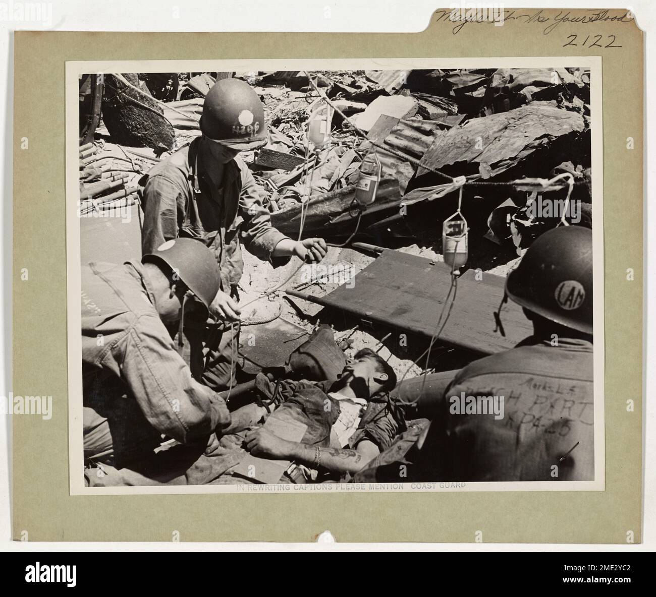 Bottles of blood plasma hang at a first aid station on the beach at ...