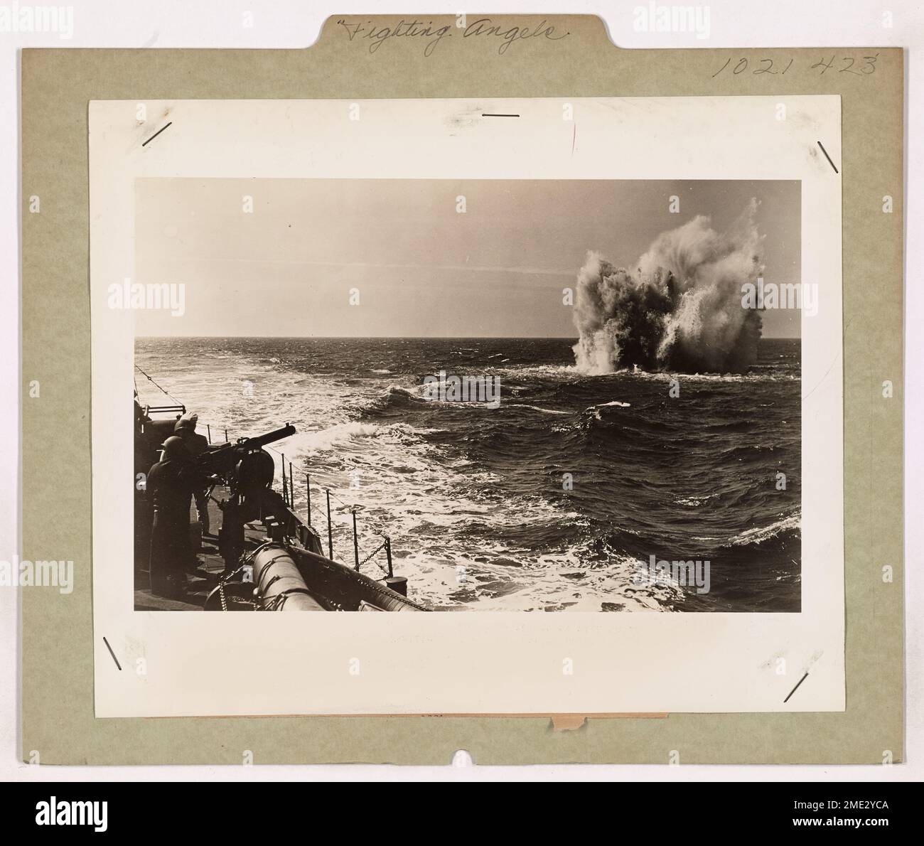 A depth charge explodes, shattering a submarine, while a Coast Guard ...