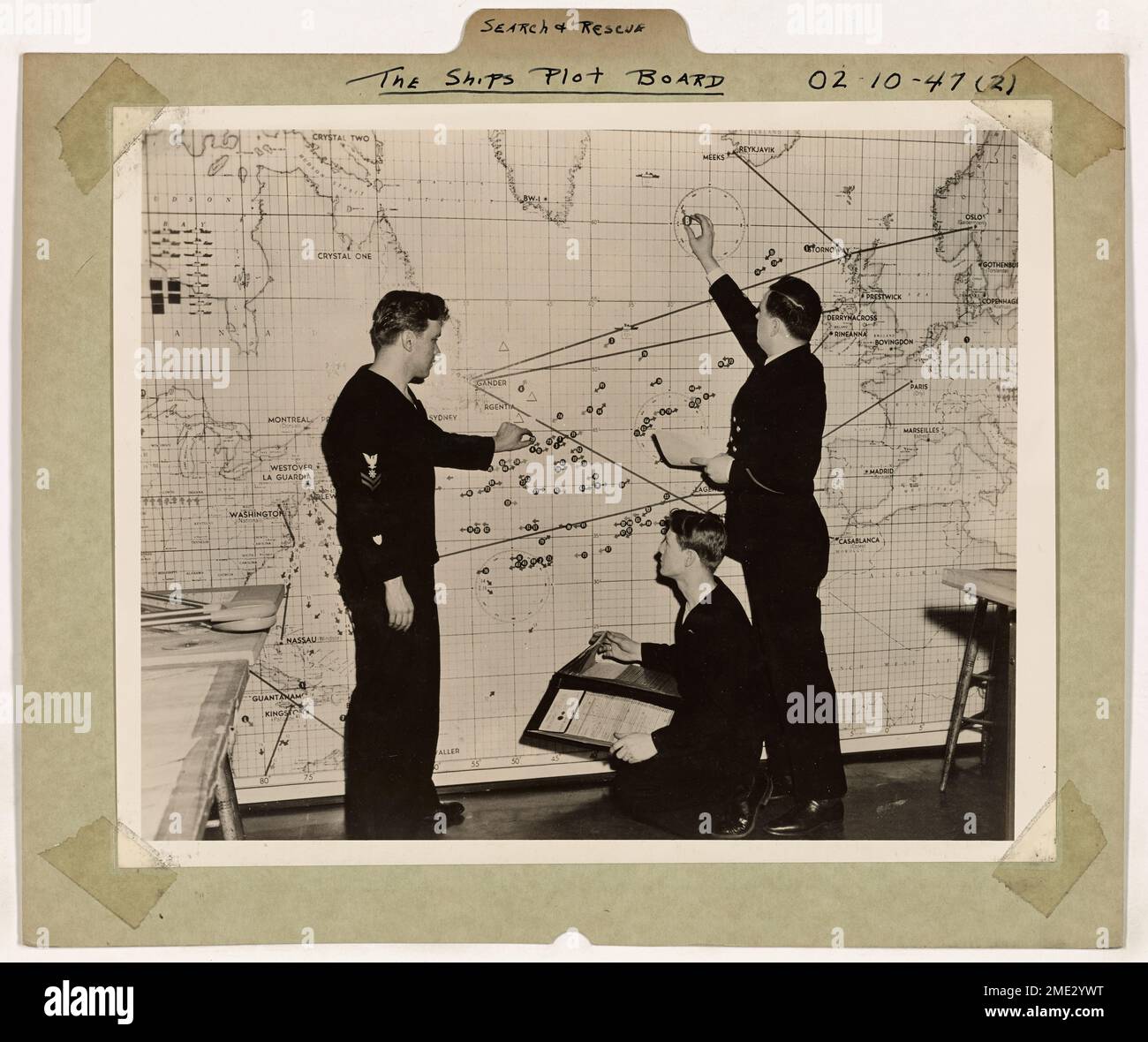 Coast Guardsmen monitor the status of major vessels navigating between ...